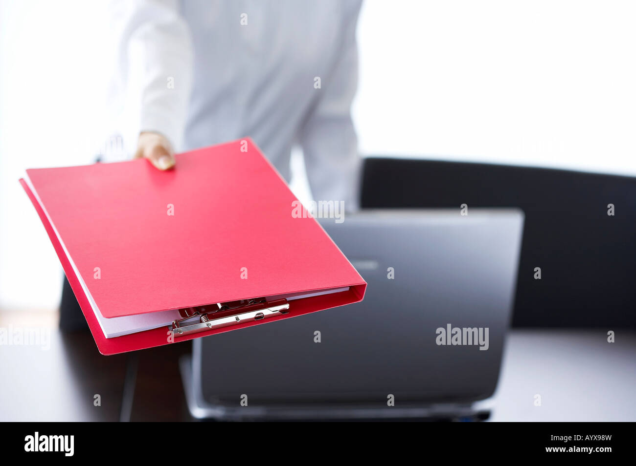man giving out red document file Stock Photo - Alamy