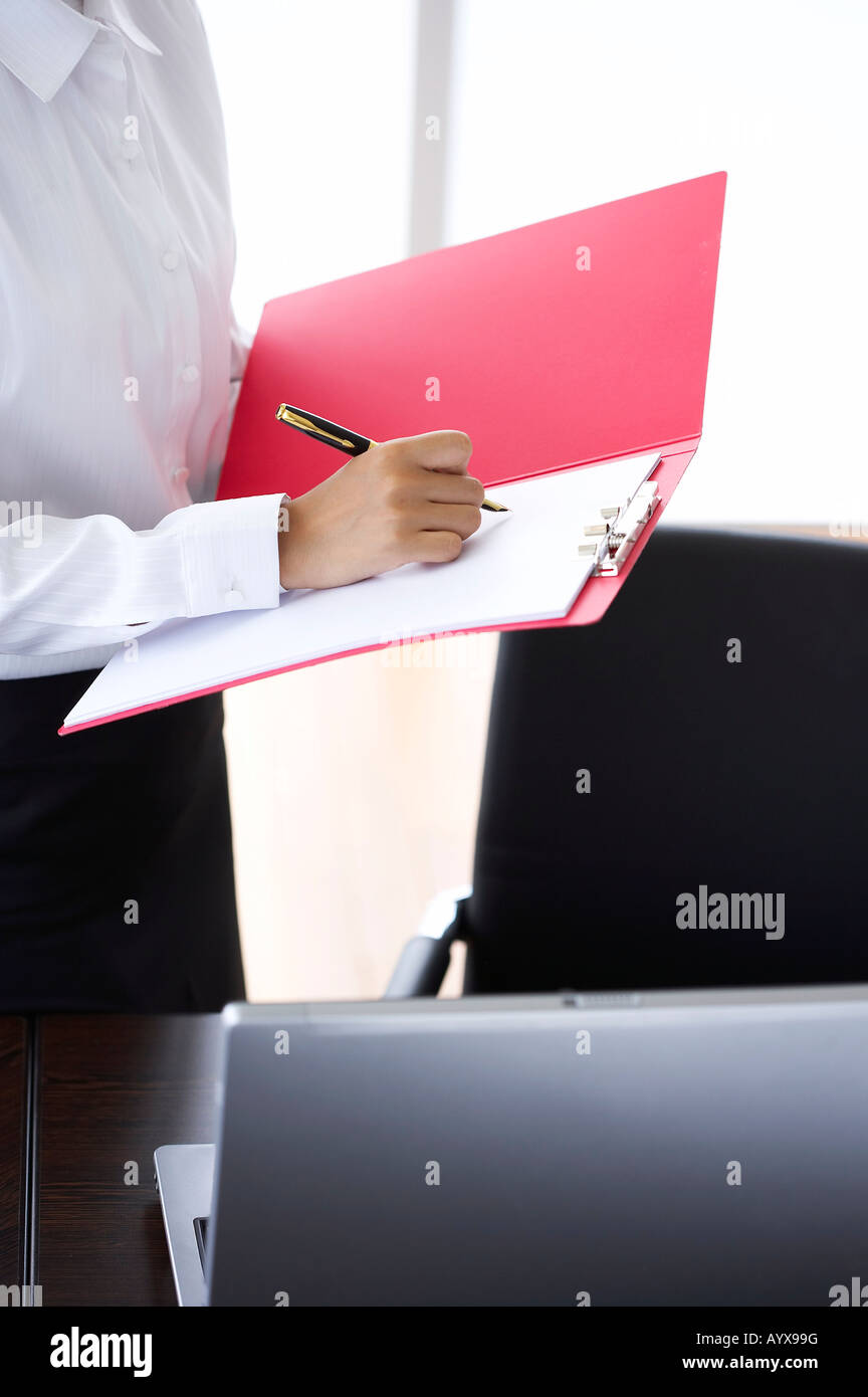 man arranging document file near table Stock Photo - Alamy