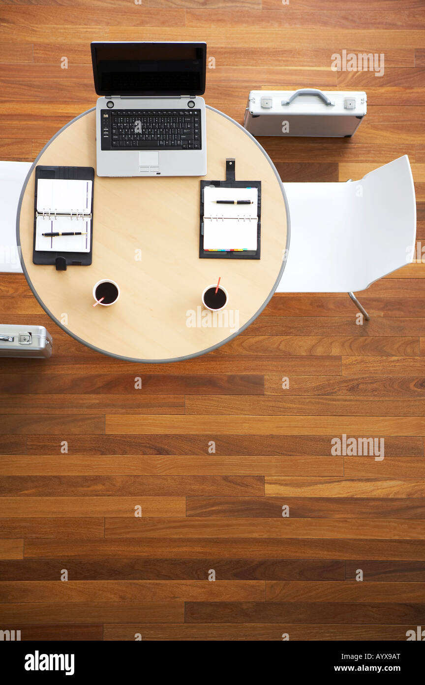 round table with notebook on and chair at high angle Stock Photo - Alamy