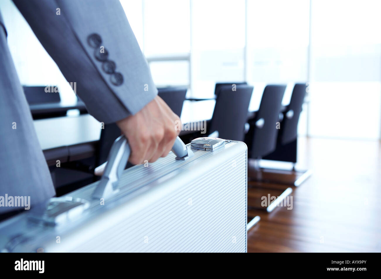 hand holding briefcase in the conferrence room Stock Photo - Alamy
