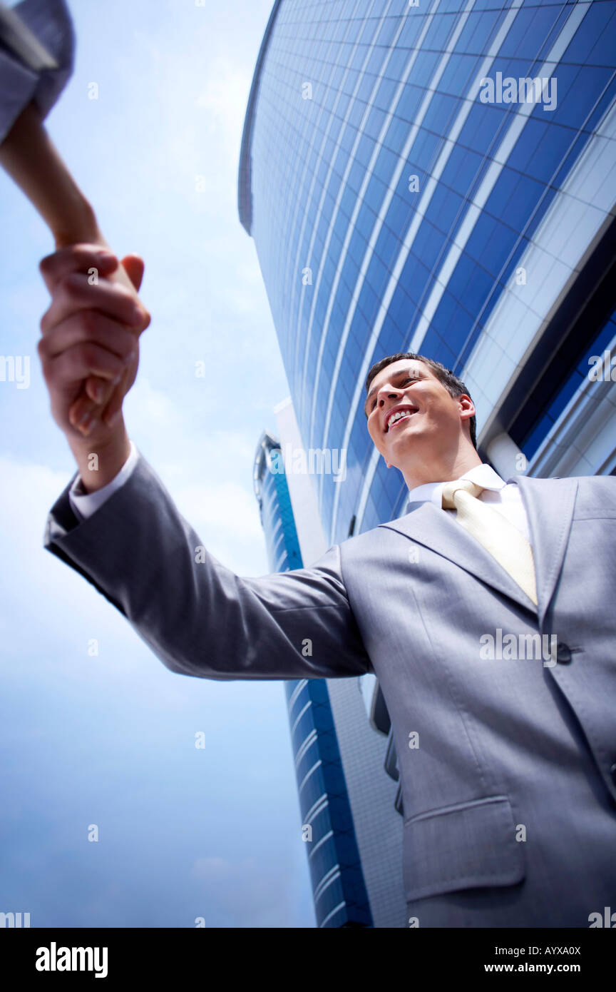 woman shaking hands at low angle Stock Photo - Alamy
