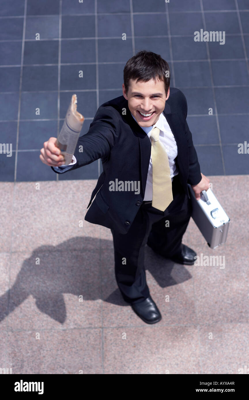 man holding newspaper and briefcase Stock Photo - Alamy