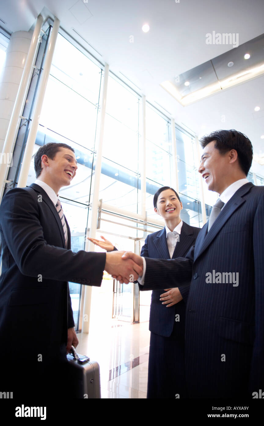 man shaking hand and woman introducing someone Stock Photo - Alamy
