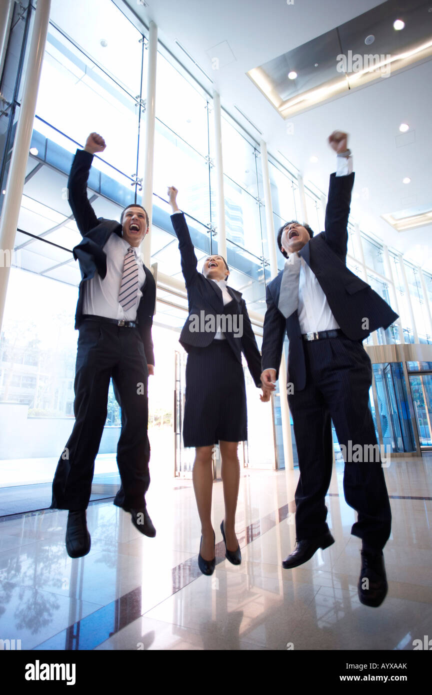 cheering man and woman while jumping Stock Photo - Alamy