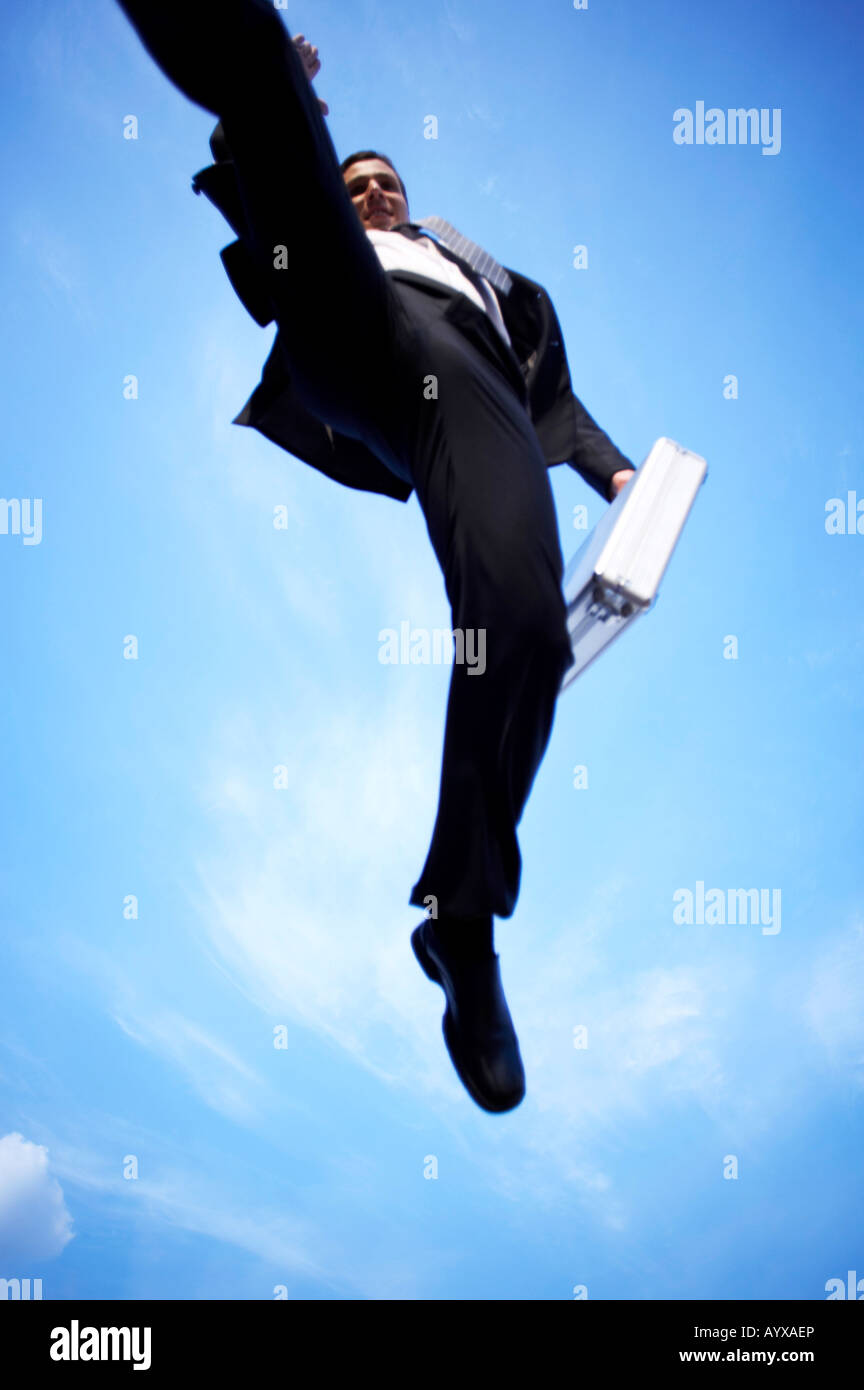 jumping man with blue sky background at low angle Stock Photo - Alamy