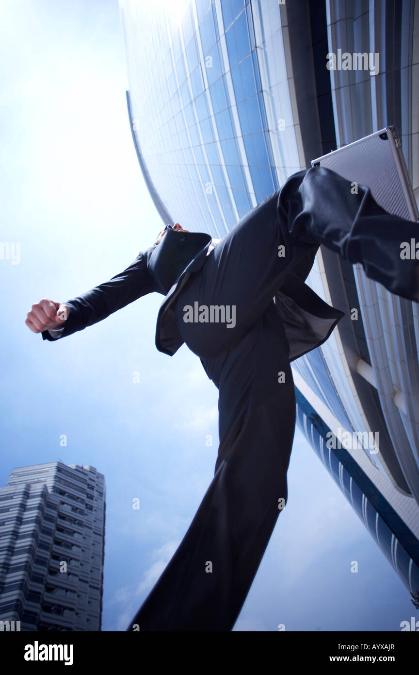 man running in front of the building at low angle Stock Photo - Alamy