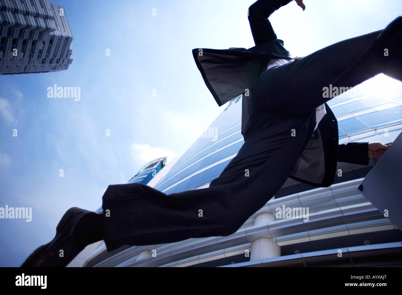 man running in front of the building at low angle Stock Photo - Alamy