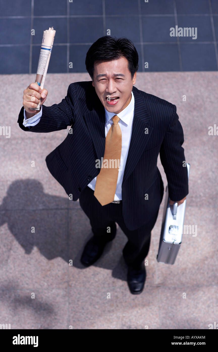 cheering man holding newspaper and documents Stock Photo - Alamy