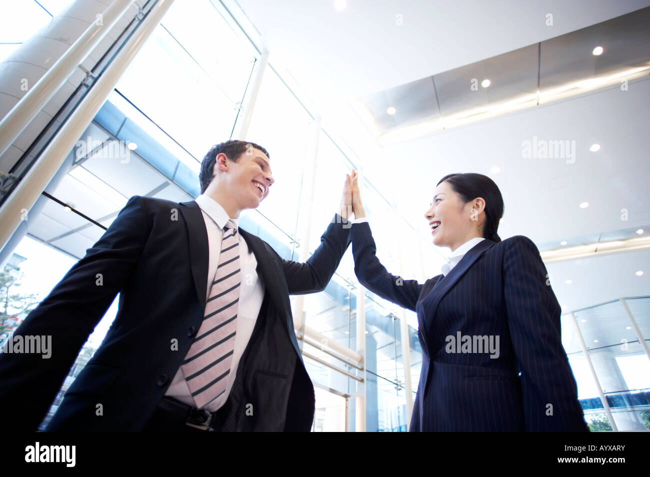 man and woman with high five Stock Photo - Alamy