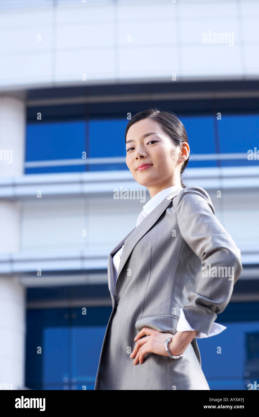 a business woman putting hands on waist Stock Photo - Alamy