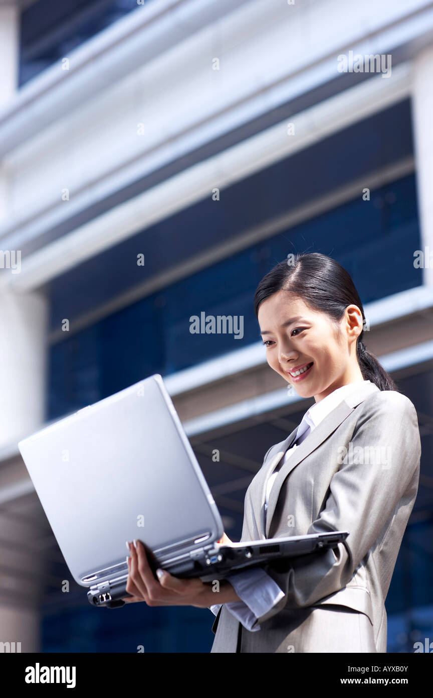 a bussiness woman using laptop computer on her hands Stock Photo - Alamy