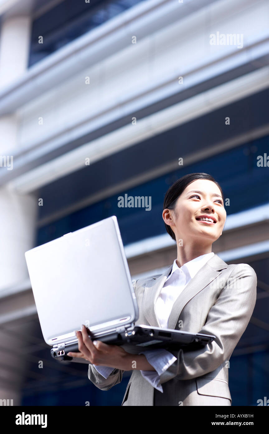 a bussiness woman seeing the side by putting laptop computer on her ...