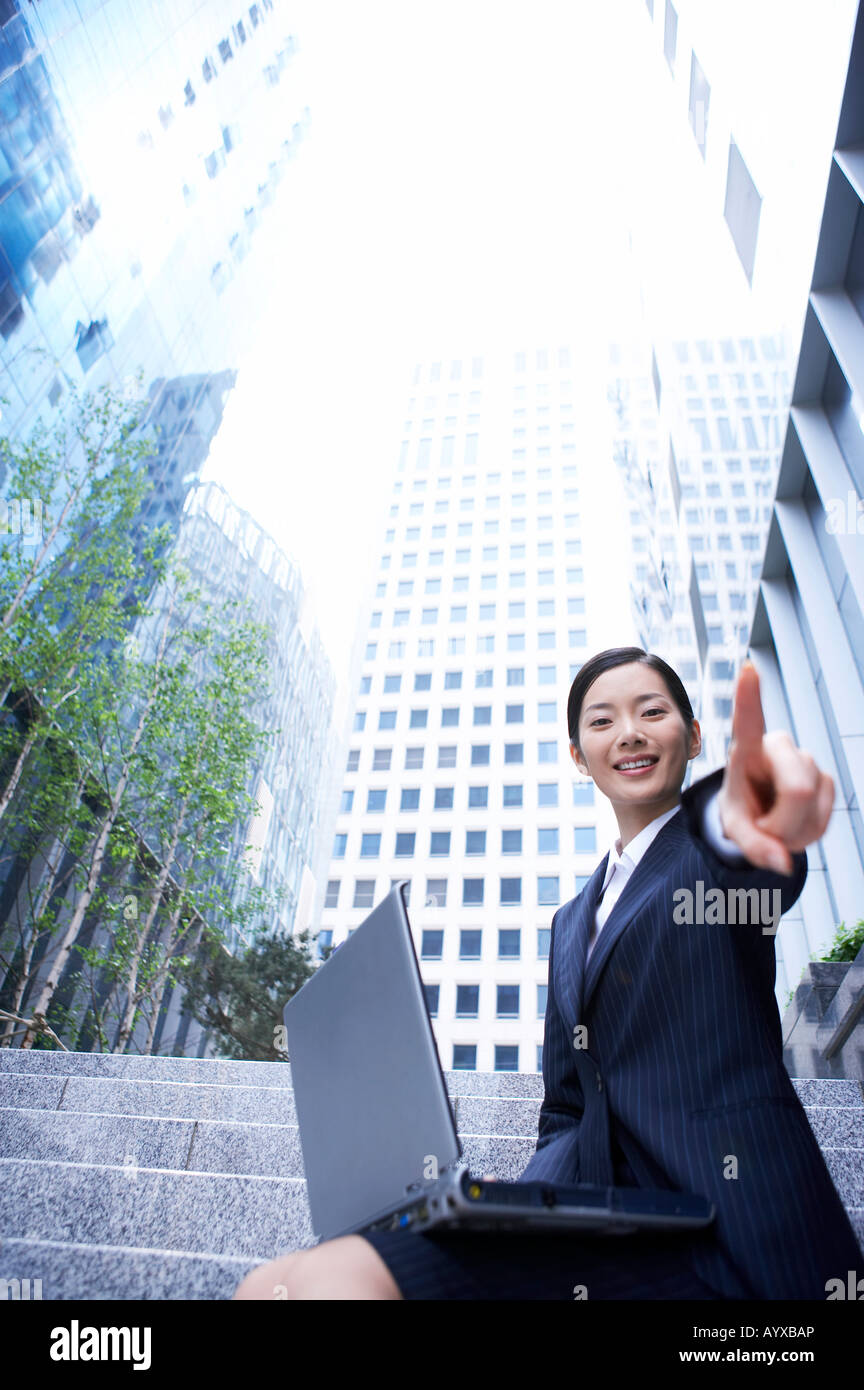 a woman using laptop computer with pointing out the front Stock Photo ...