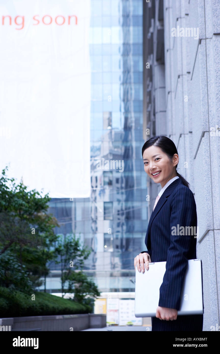 a woman holding laptop computer by a hand Stock Photo - Alamy