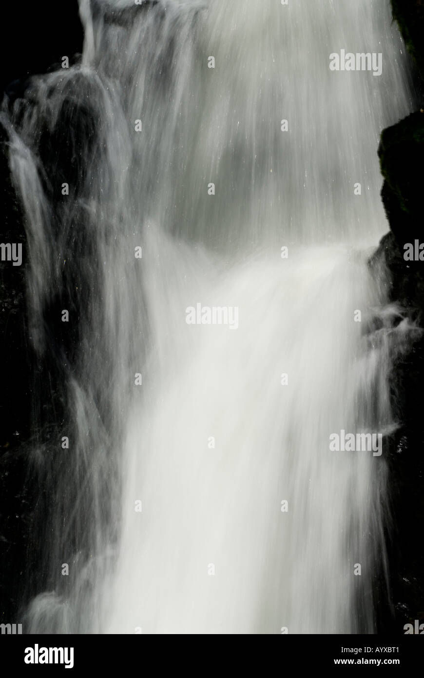 Waterfall in full spate taken with a slow shutter speed to blur the ...