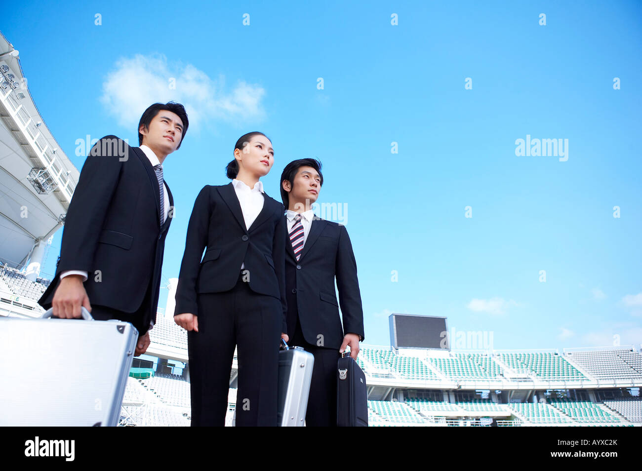 three person staring at somewhere in arena Stock Photo - Alamy