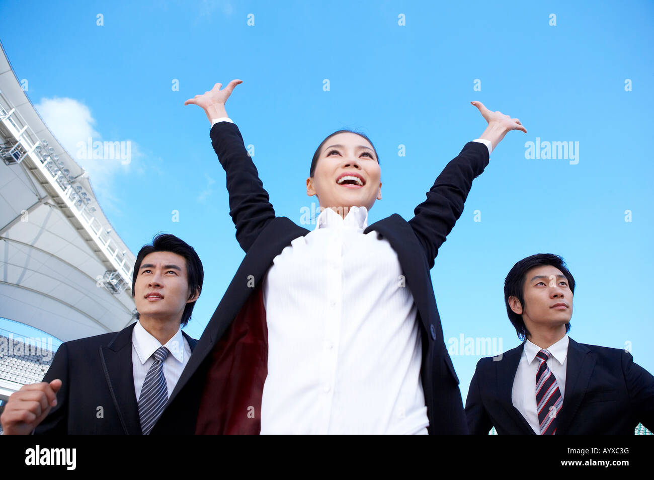 three person giving cheers in the middle of arena Stock Photo - Alamy