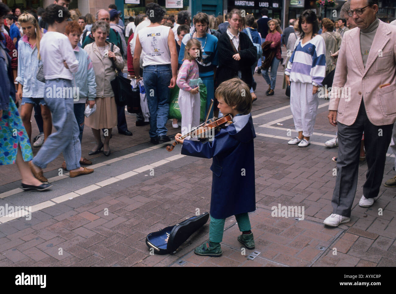A small boy busker plays his fiddle in Grafton Street, Dublin Street ...