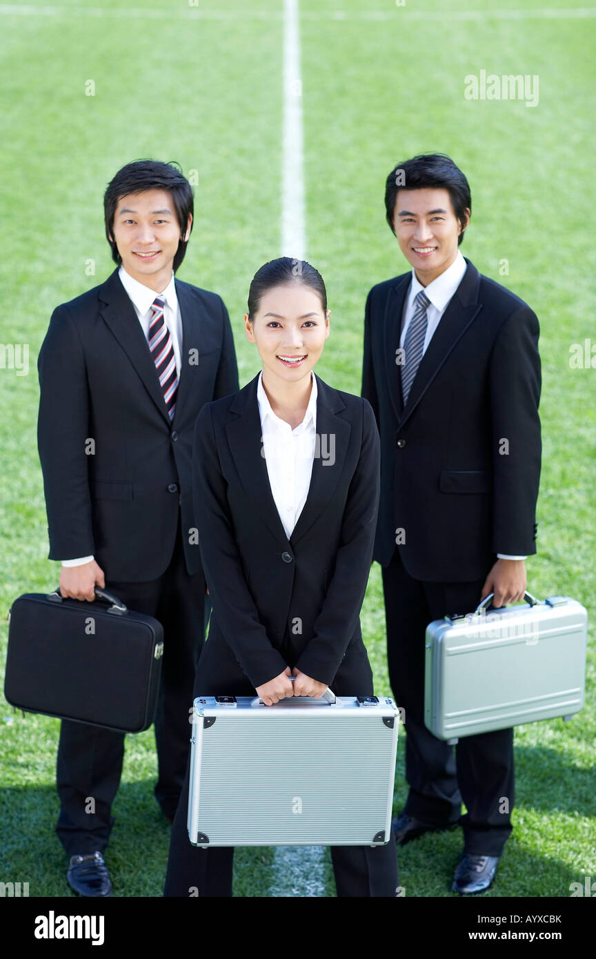 three standing person staring at somewhere in arena Stock Photo - Alamy
