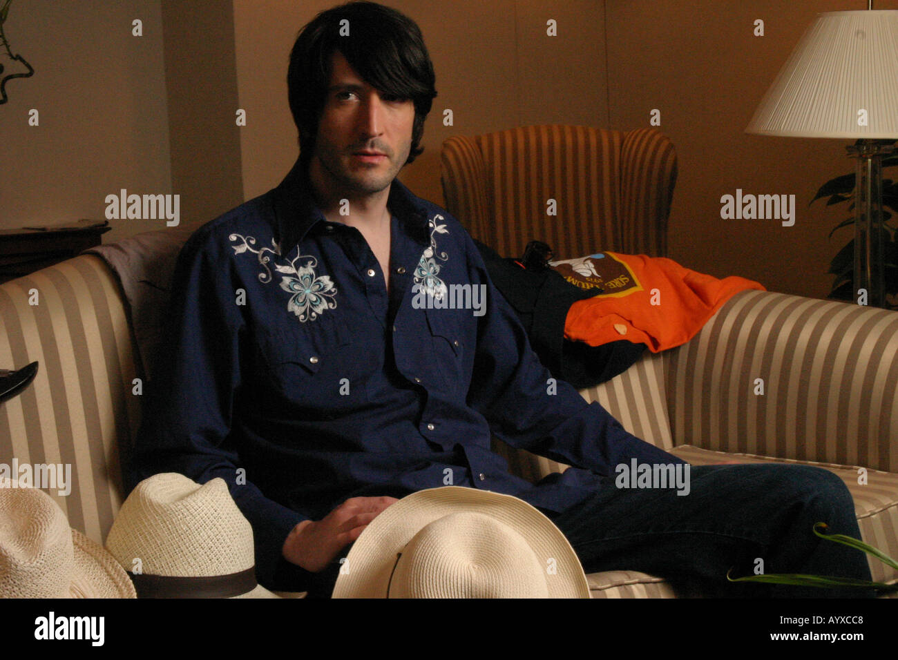 Louis Eliot sitting on a sofa surrounded by clothes while doing a ...