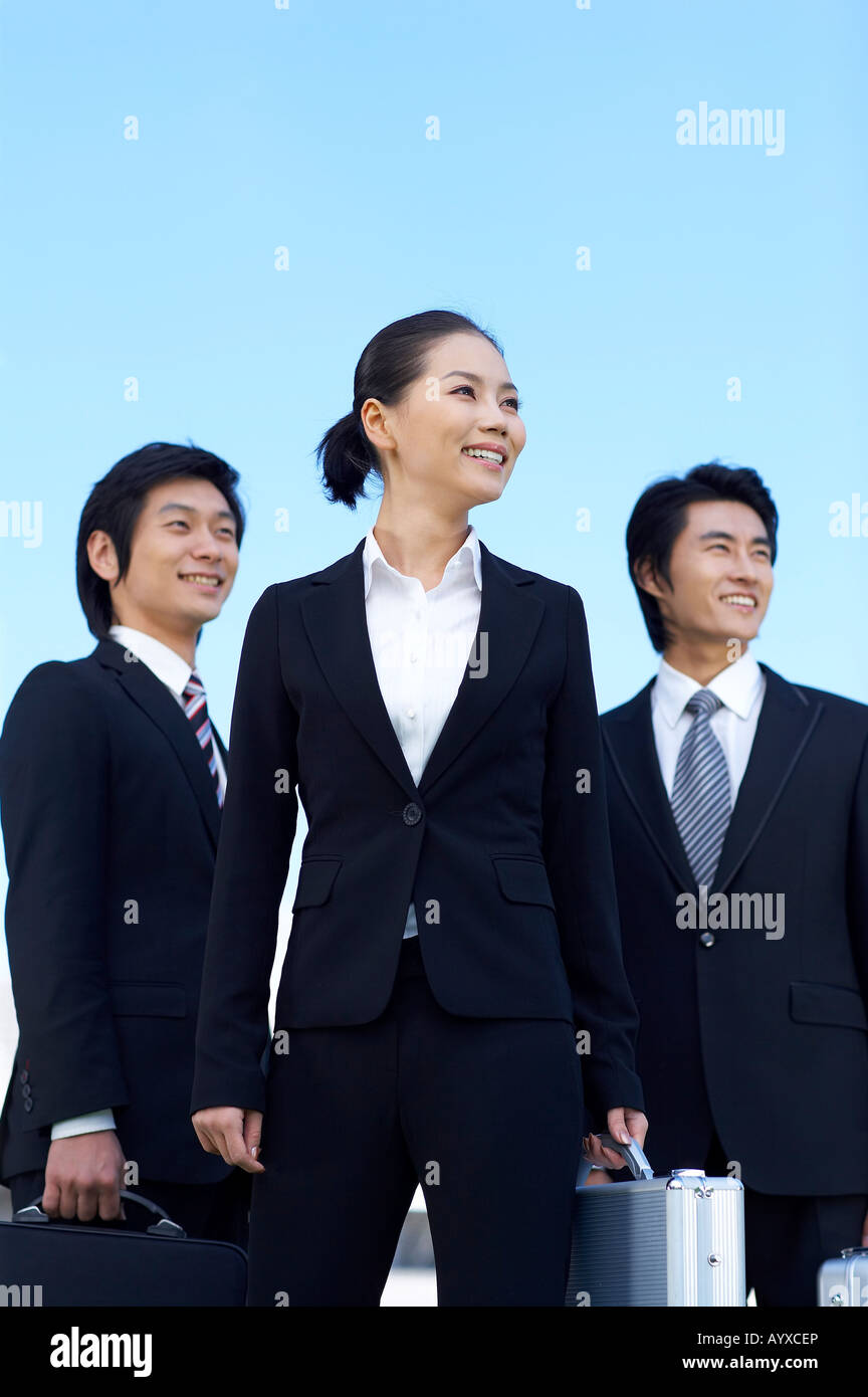 three person being smile with seeing the side Stock Photo - Alamy