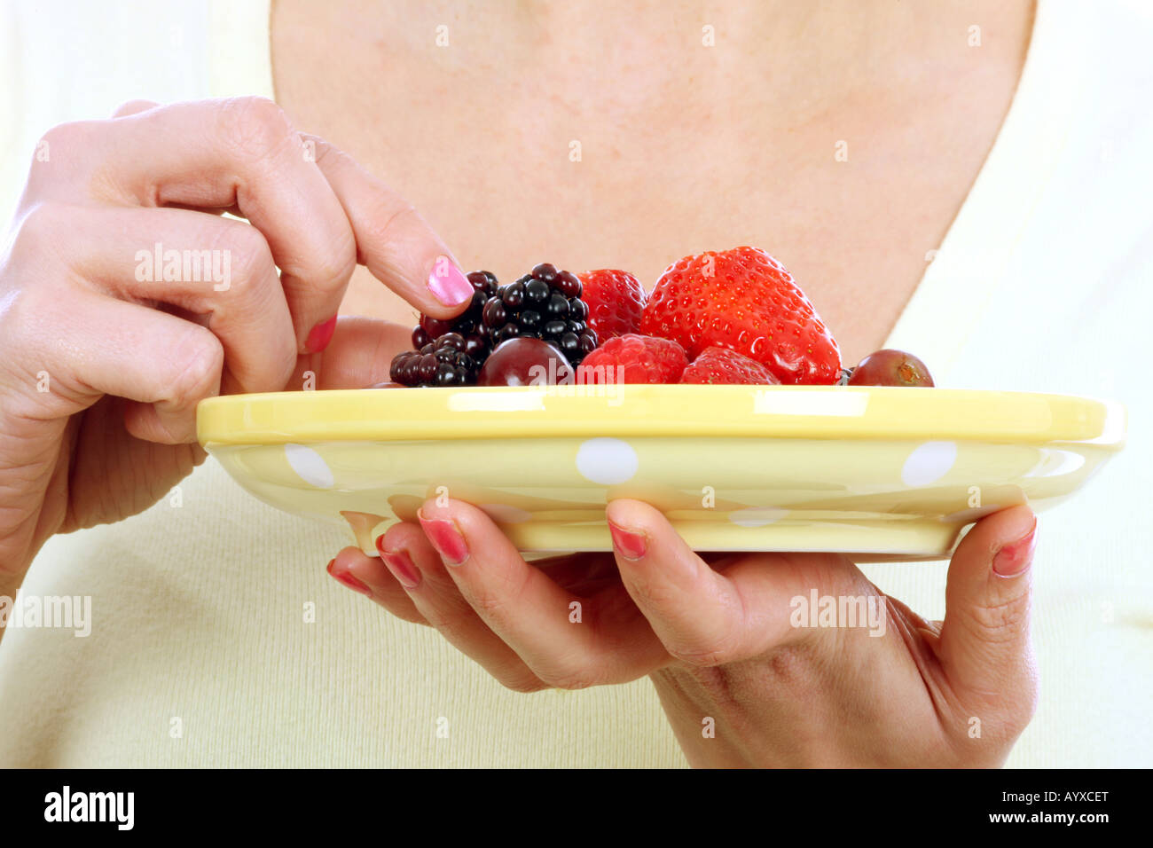 Young Woman Eating Mixed Berries Model Released Stock Photo - Alamy