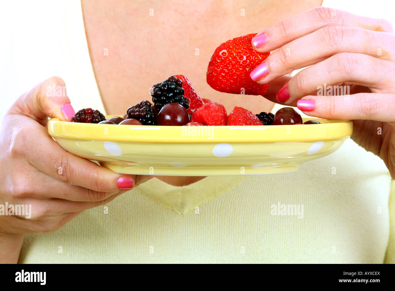 Young Woman Eating Mixed Berries Model Released Stock Photo - Alamy