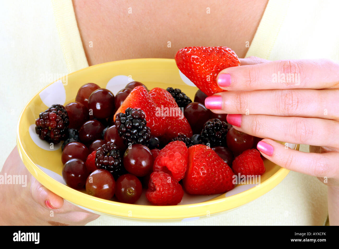 Young Woman Eating Mixed Berries Model Released Stock Photo - Alamy