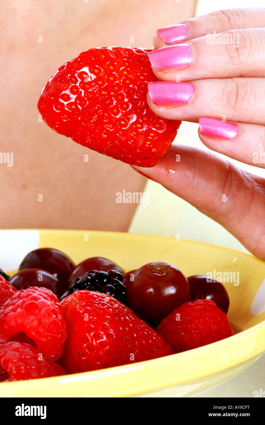 Young Woman Eating Mixed Berries Model Released Stock Photo - Alamy