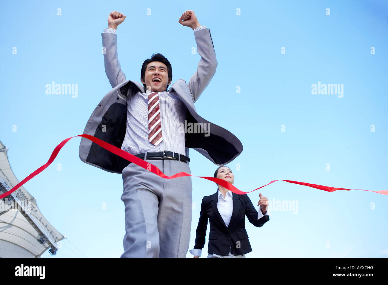 a man and woman entering the finish line with a smile Stock Photo - Alamy