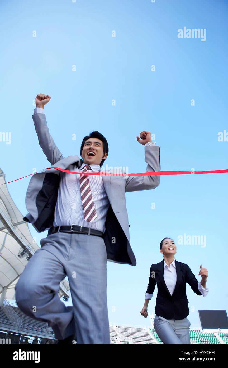 a man and woman entering the finish line with a smile Stock Photo - Alamy