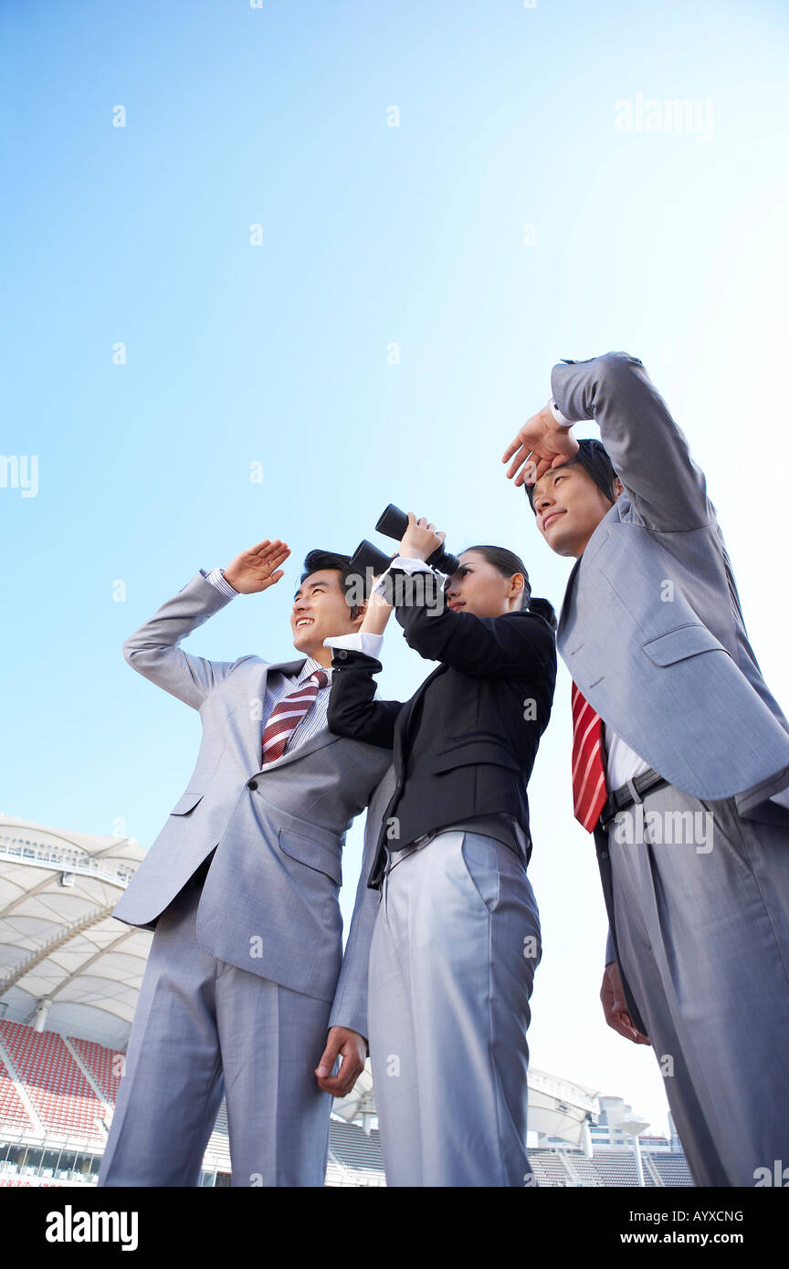 three person looking at somewhre through binocular Stock Photo - Alamy