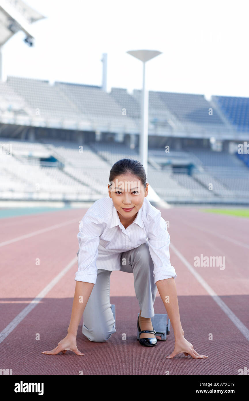 a woman is standing at the starting line Stock Photo - Alamy