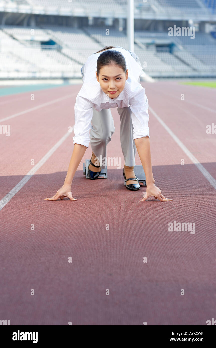 a woman is standing at the starting line Stock Photo - Alamy