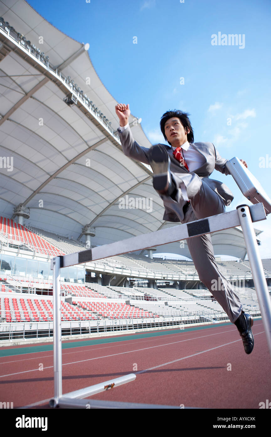 a man running over an obstacle Stock Photo - Alamy