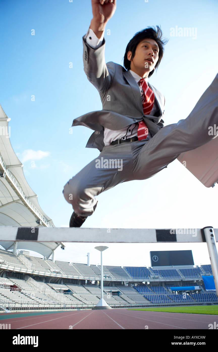 a man running over an obstacle Stock Photo - Alamy