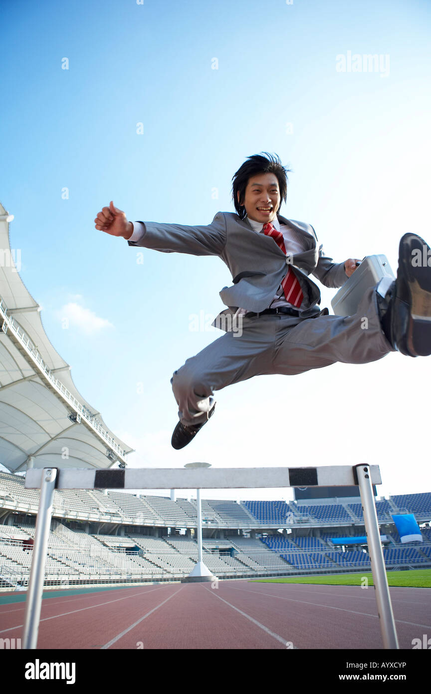 a man running over an obstacle Stock Photo - Alamy