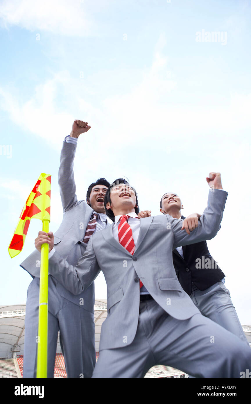 a flag and three person cheering Stock Photo - Alamy