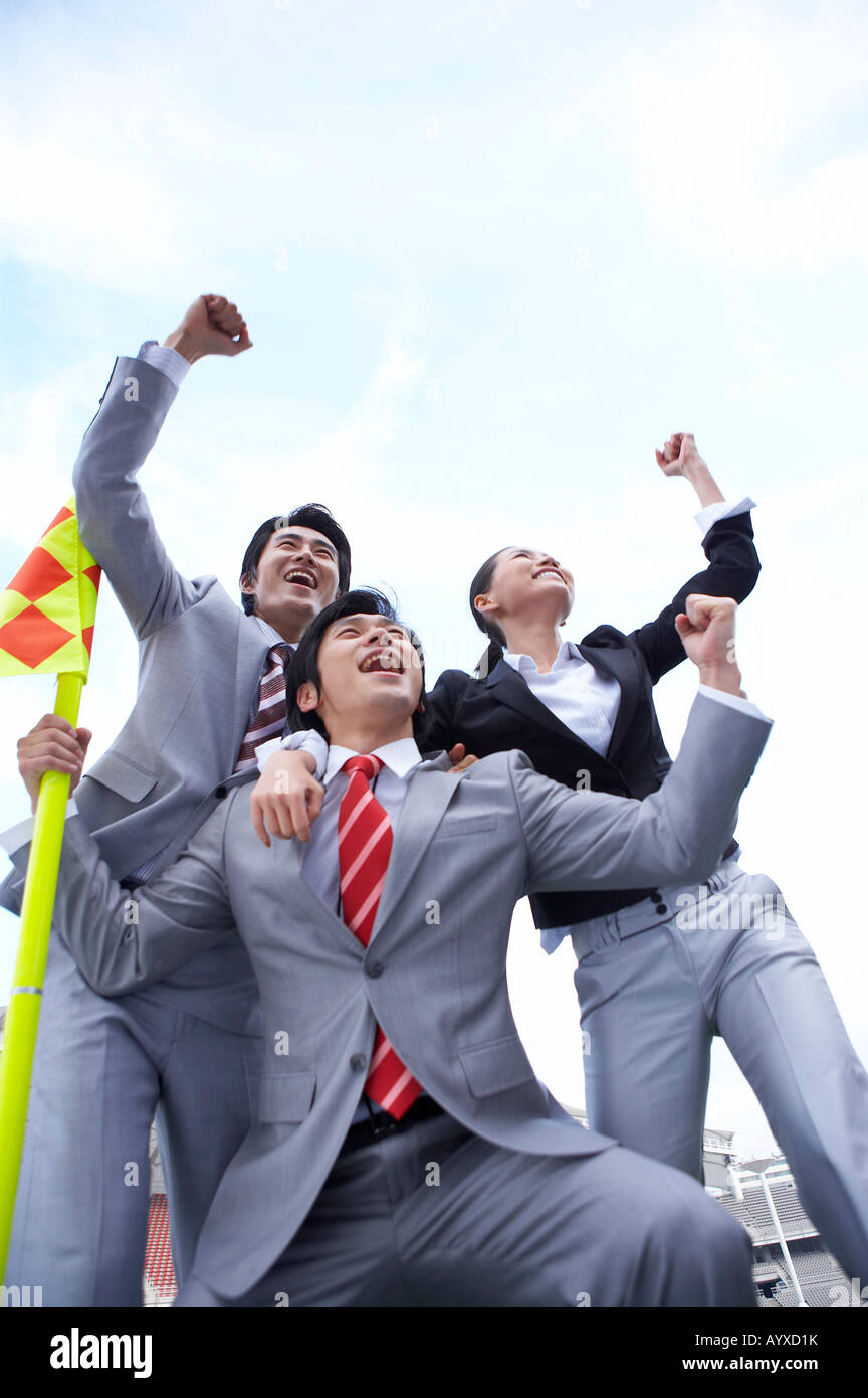 a flag and three person cheering Stock Photo - Alamy