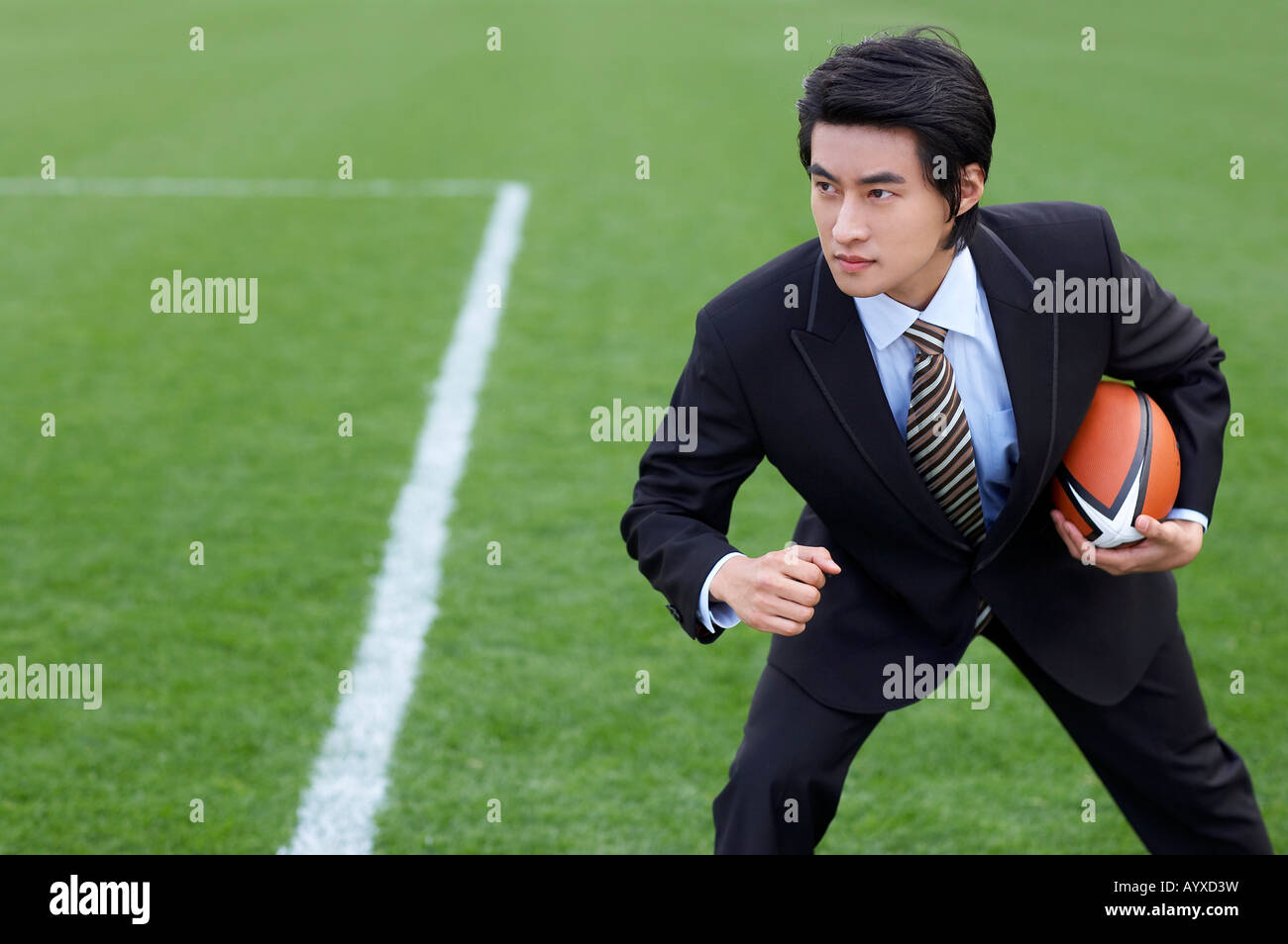 a man setting run up with holding Rugby ball Stock Photo - Alamy