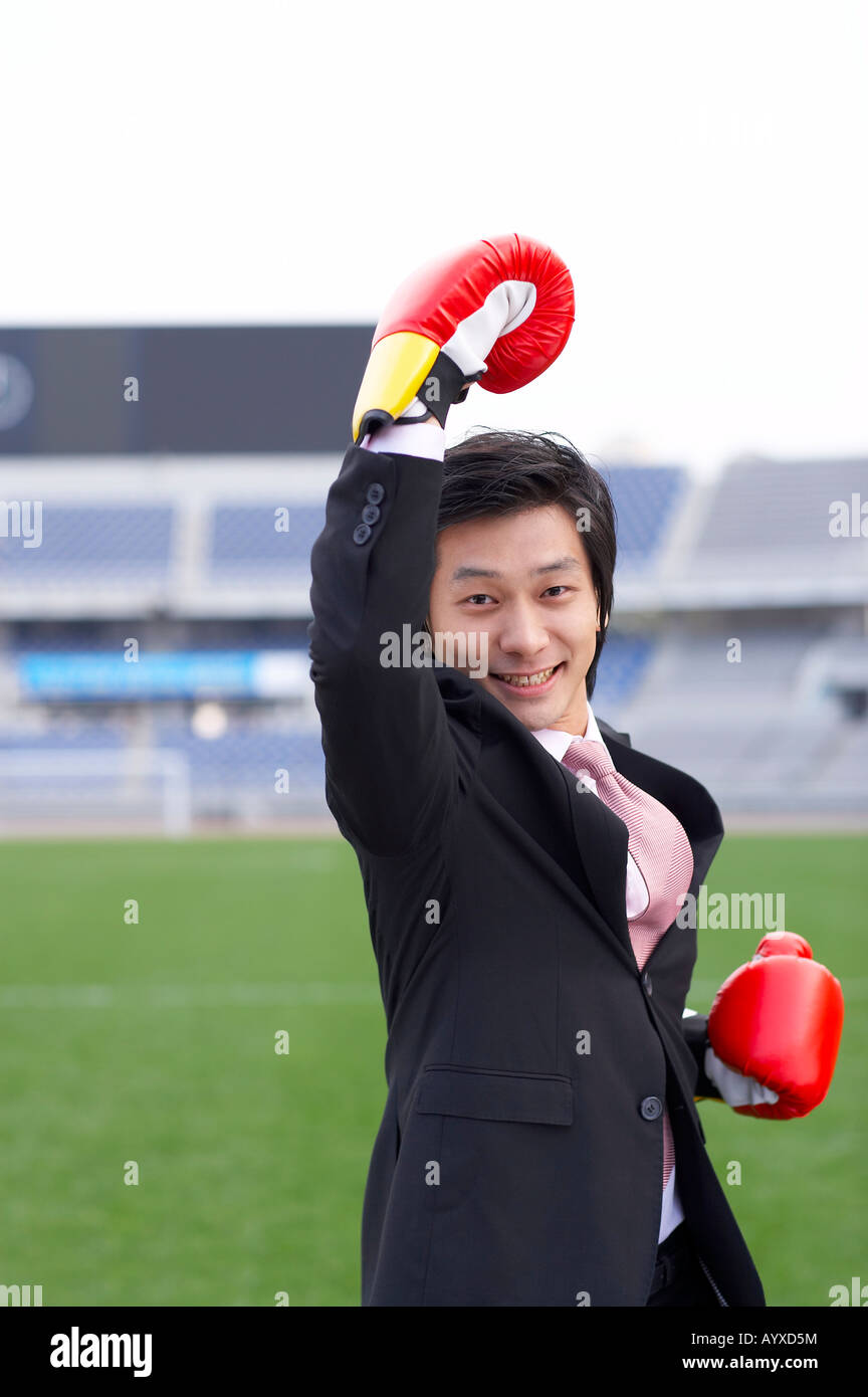 a man being smile with putting on boxing glove Stock Photo - Alamy