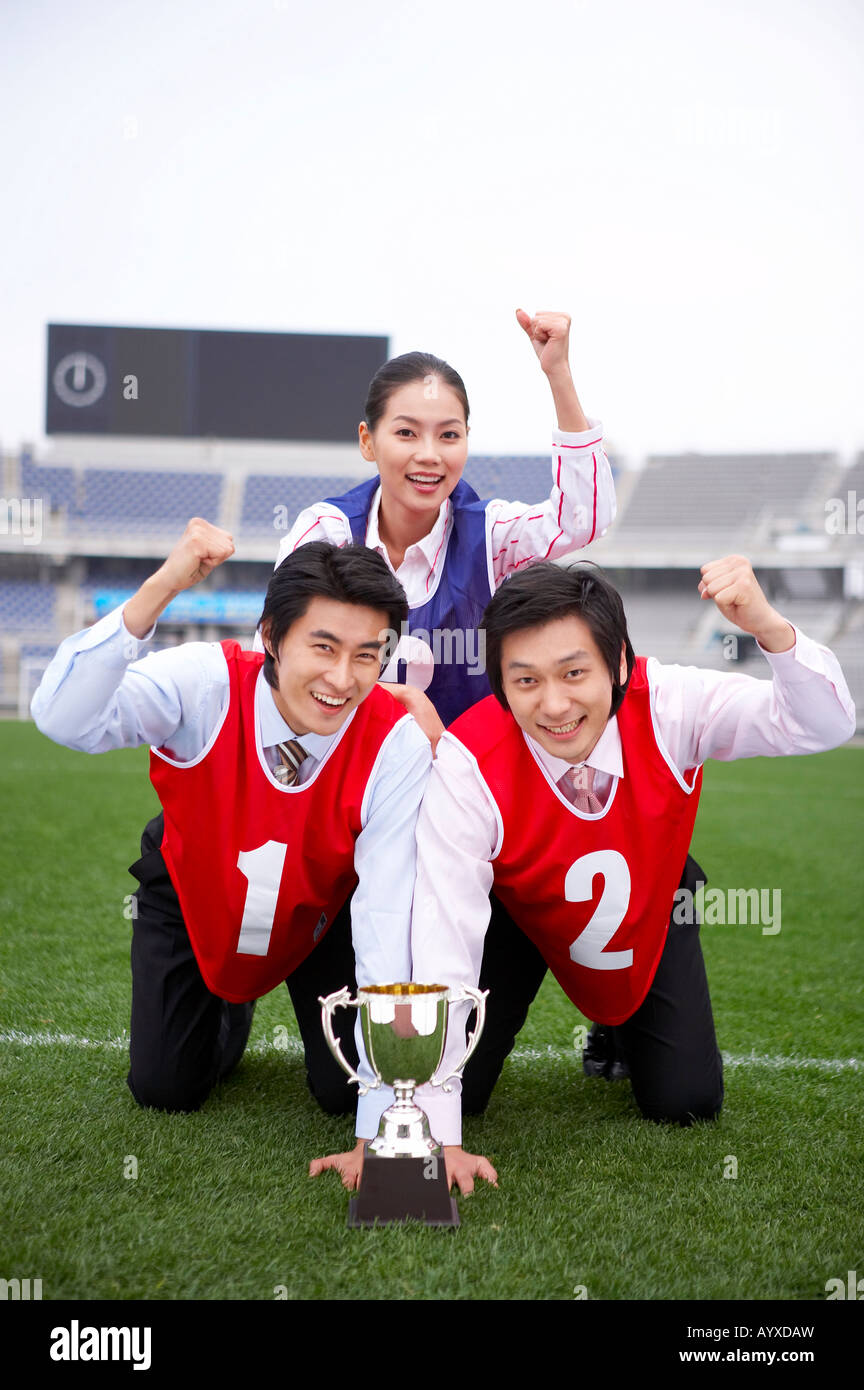 trophy, three person wore uniform with motioning human pyramid Stock ...