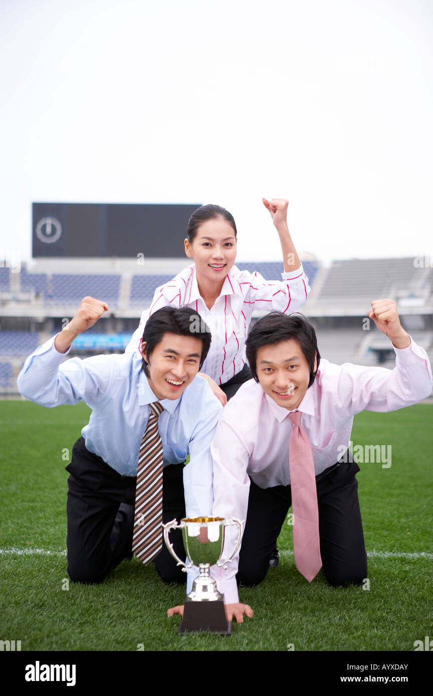 trophy, three person with motioning human pyramid Stock Photo - Alamy