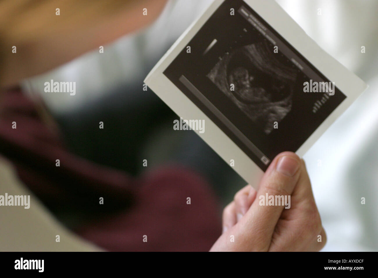 pregnant woman examining scan image Stock Photo - Alamy