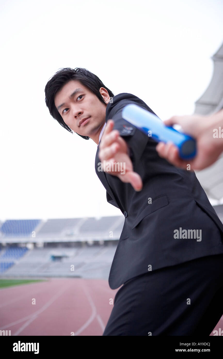 a man is being given baton Stock Photo - Alamy