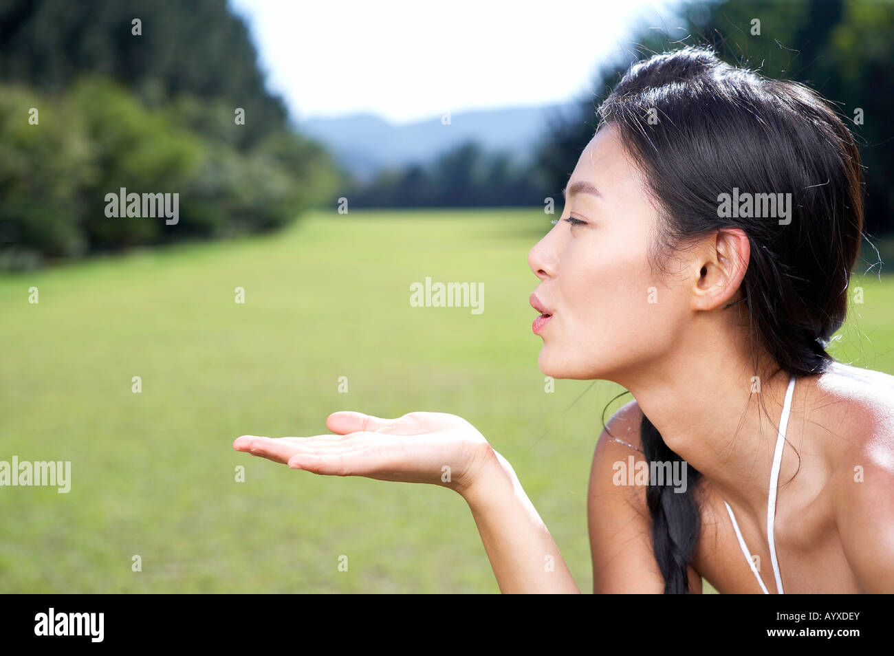 a woman blowing motion on her palm Stock Photo - Alamy