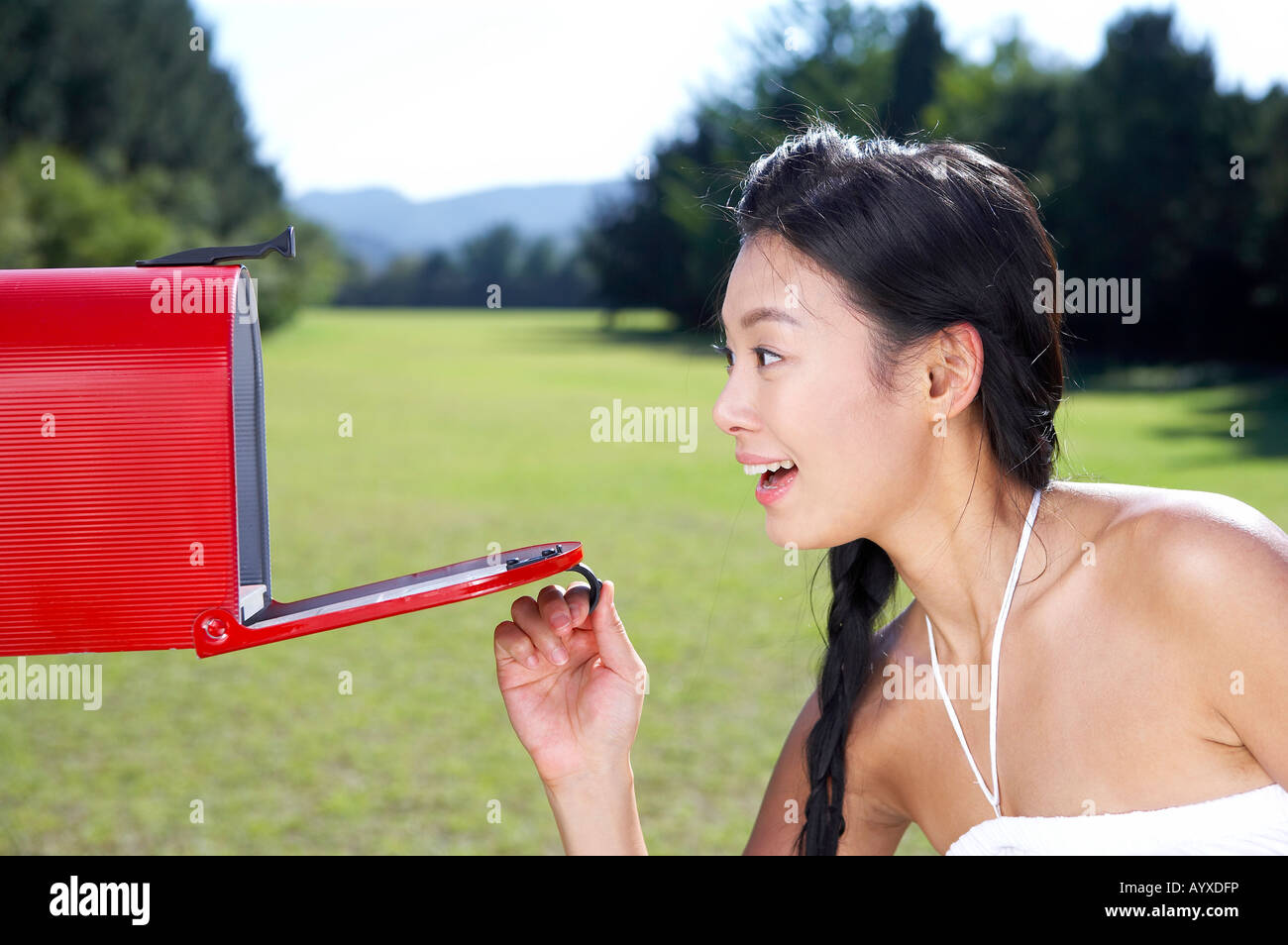 a woman opening postbox Stock Photo - Alamy