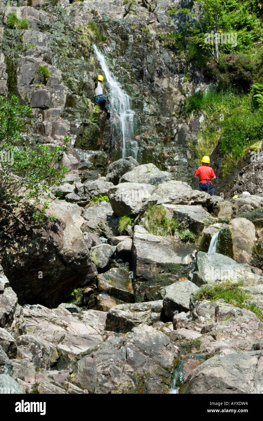 A climber heading up a gorge with waterfall and surrounding location ...