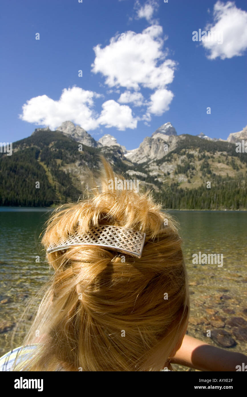 Rear view of woman s head as she looks at Taggert Lake with Grand Teton ...