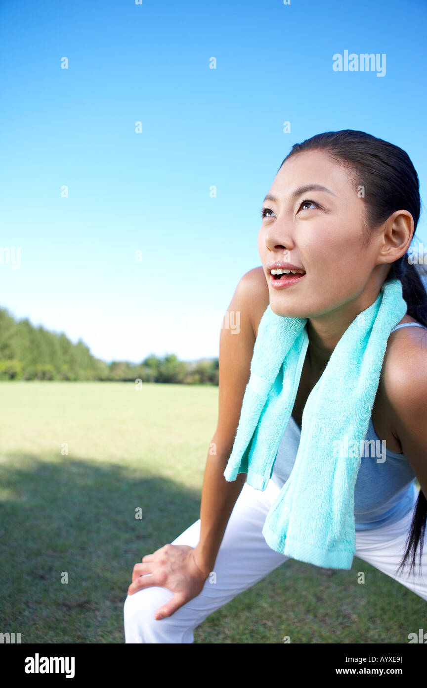 a woman putting a towel around her neck Stock Photo - Alamy